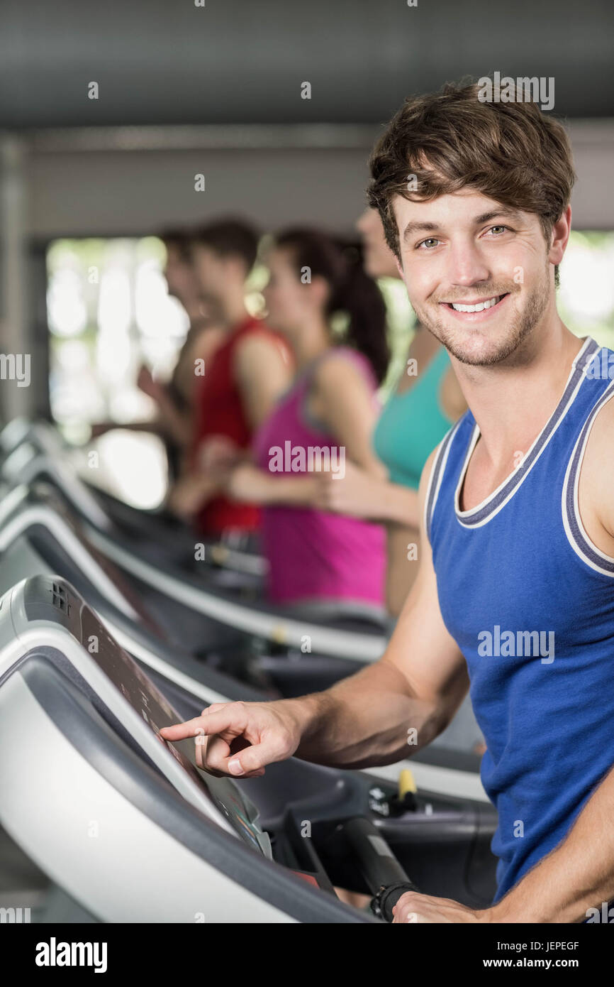 Smiling muscular man on treadmill Stock Photo - Alamy