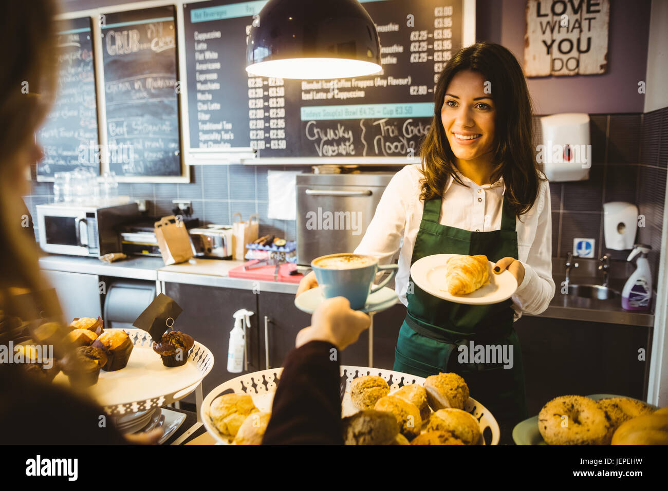 Waitress serving a cup of coffee Stock Photo - Alamy