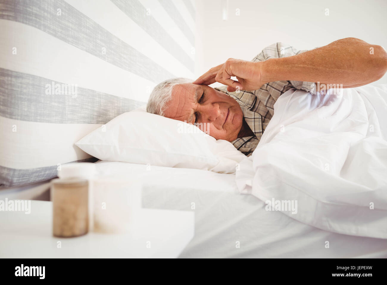 Elderly man lying in bed hi-res stock photography and images - Alamy