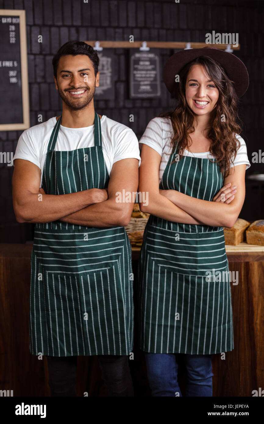 Smiling baristas standing with arms crossed Stock Photo - Alamy