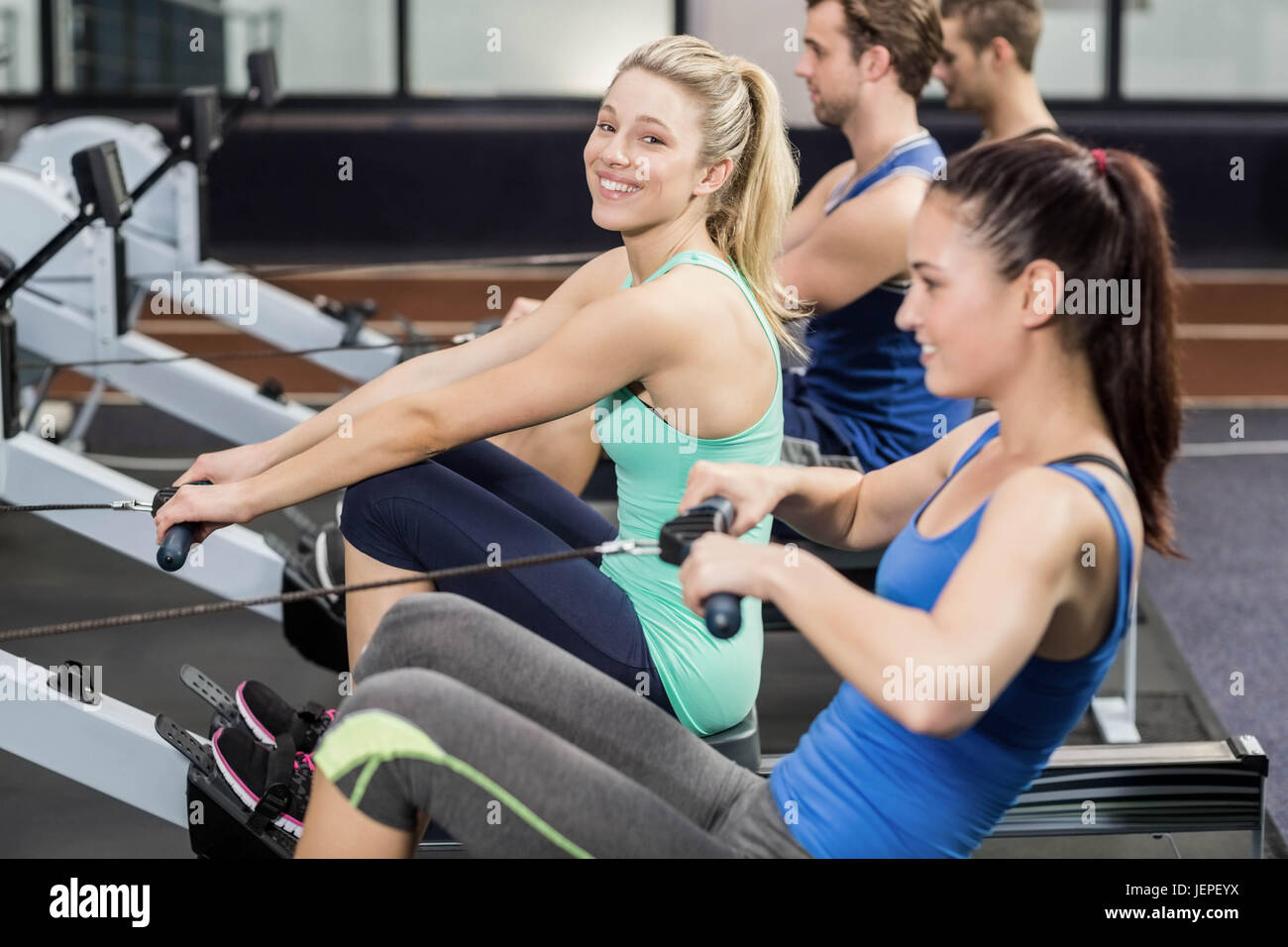Fit people on drawing machine Stock Photo - Alamy