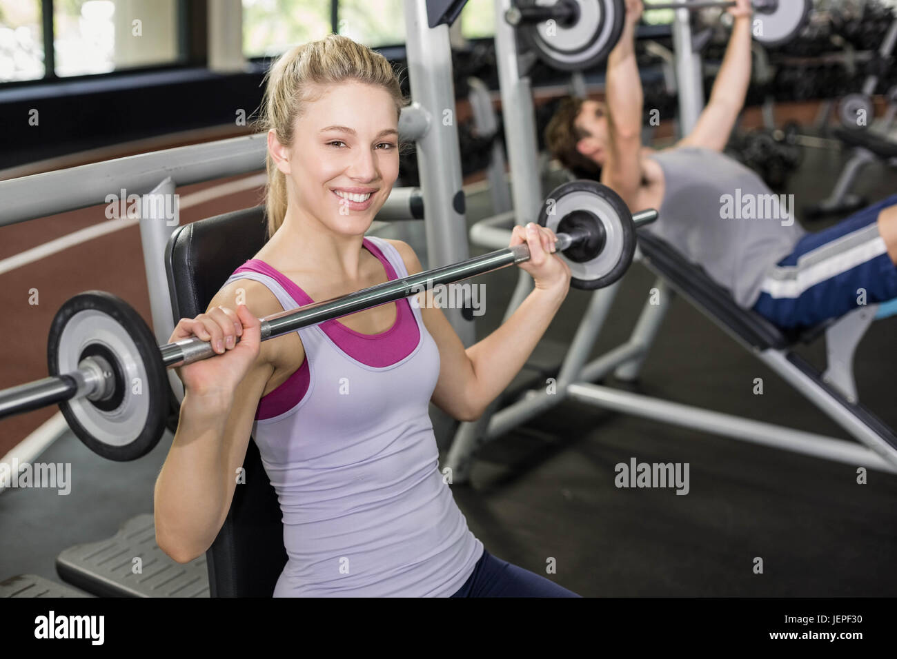 Fit woman lifting barbell Stock Photo - Alamy