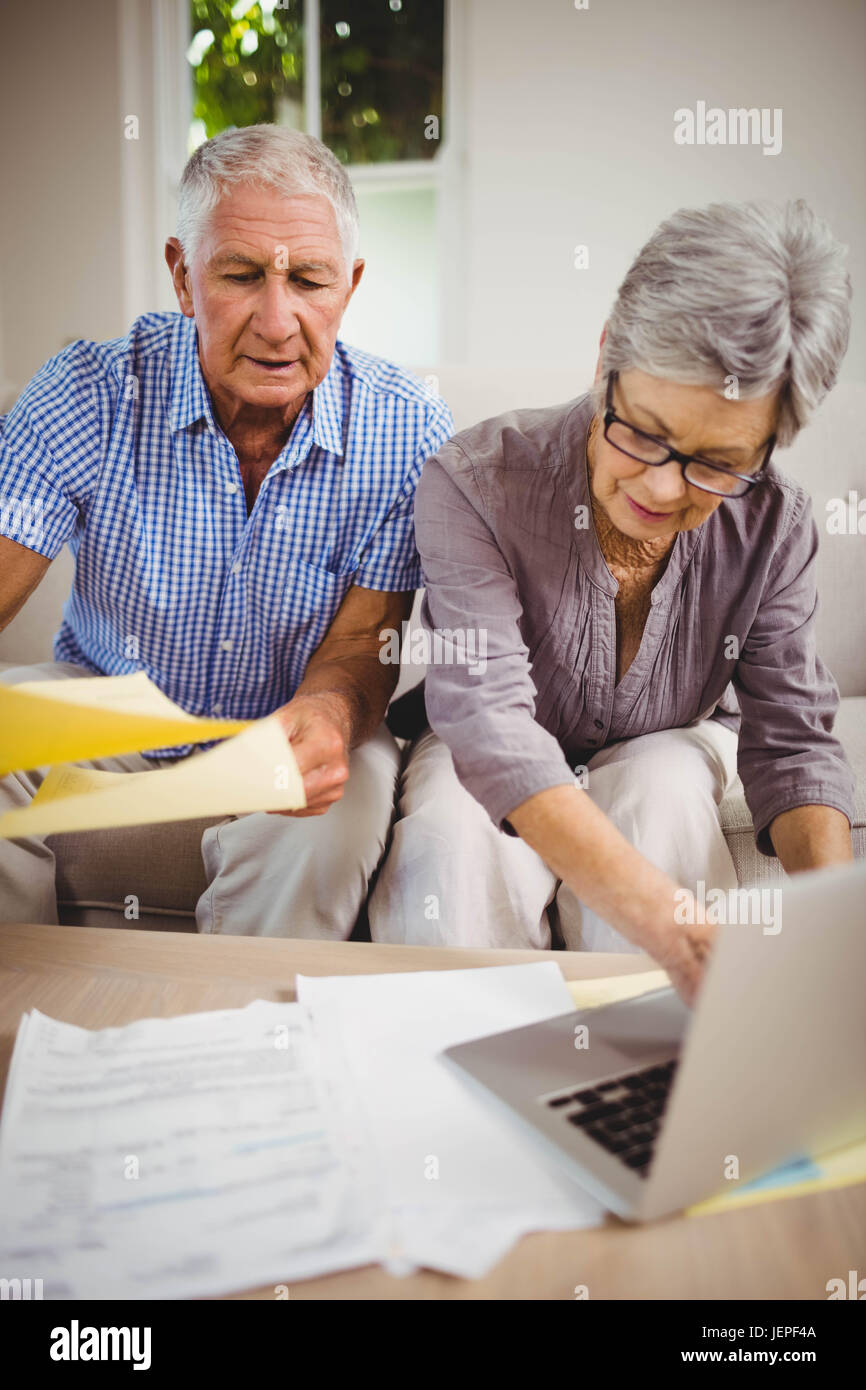 Senior woman paying bills online on laptop Stock Photo - Alamy