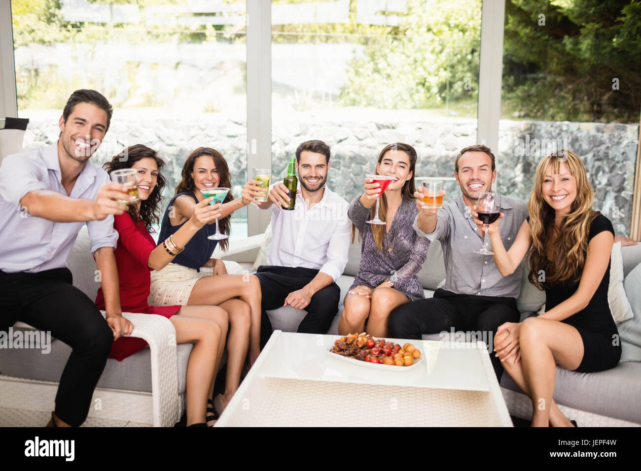 Group of friends having cocktail drinks Stock Photo - Alamy