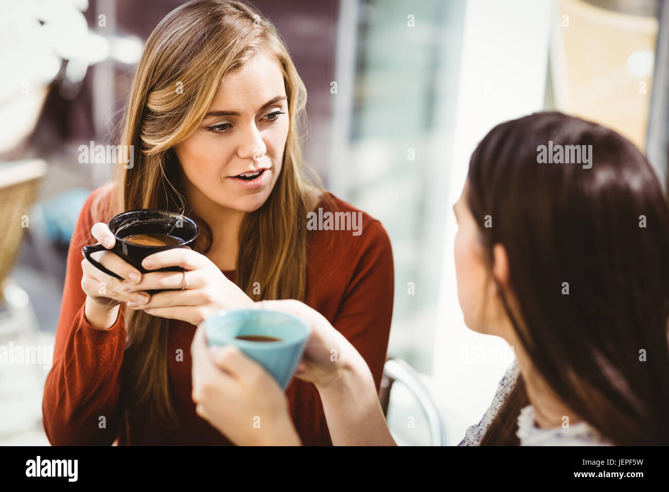 Female friends speaking cafe hi-res stock photography and images - Alamy