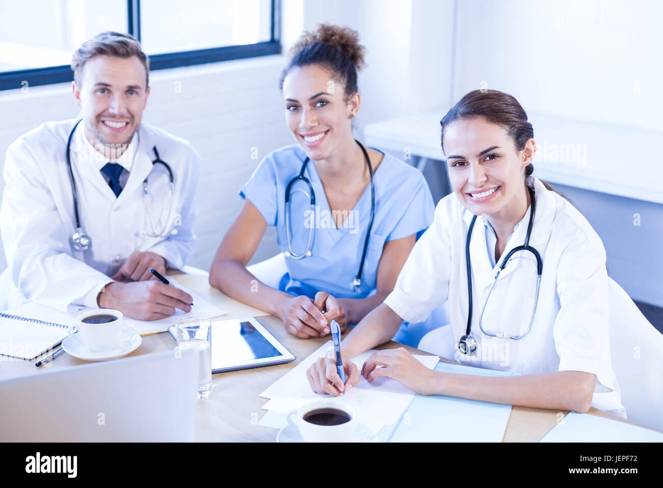 Medical team smiling at conference room Stock Photo - Alamy