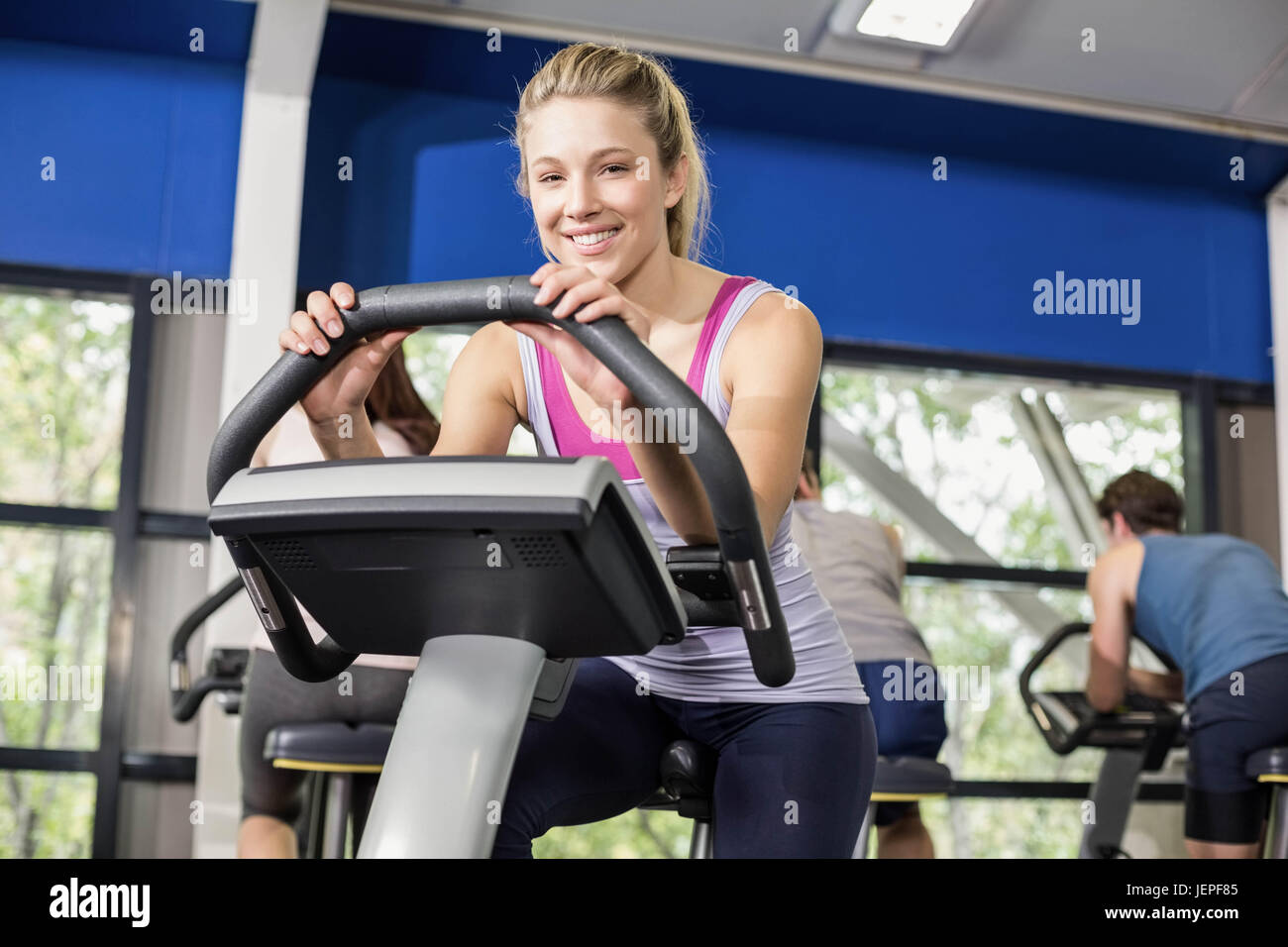 Fit woman doing exercise bike Stock Photo - Alamy