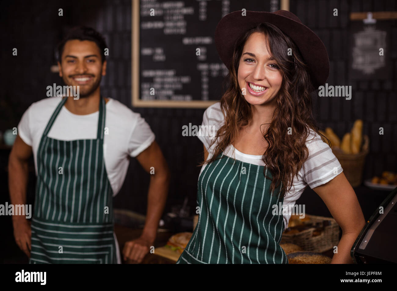 Smiling baristas looking at the camera Stock Photo - Alamy