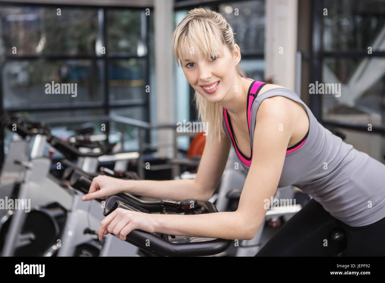 Fit woman on exercise bike Stock Photo - Alamy