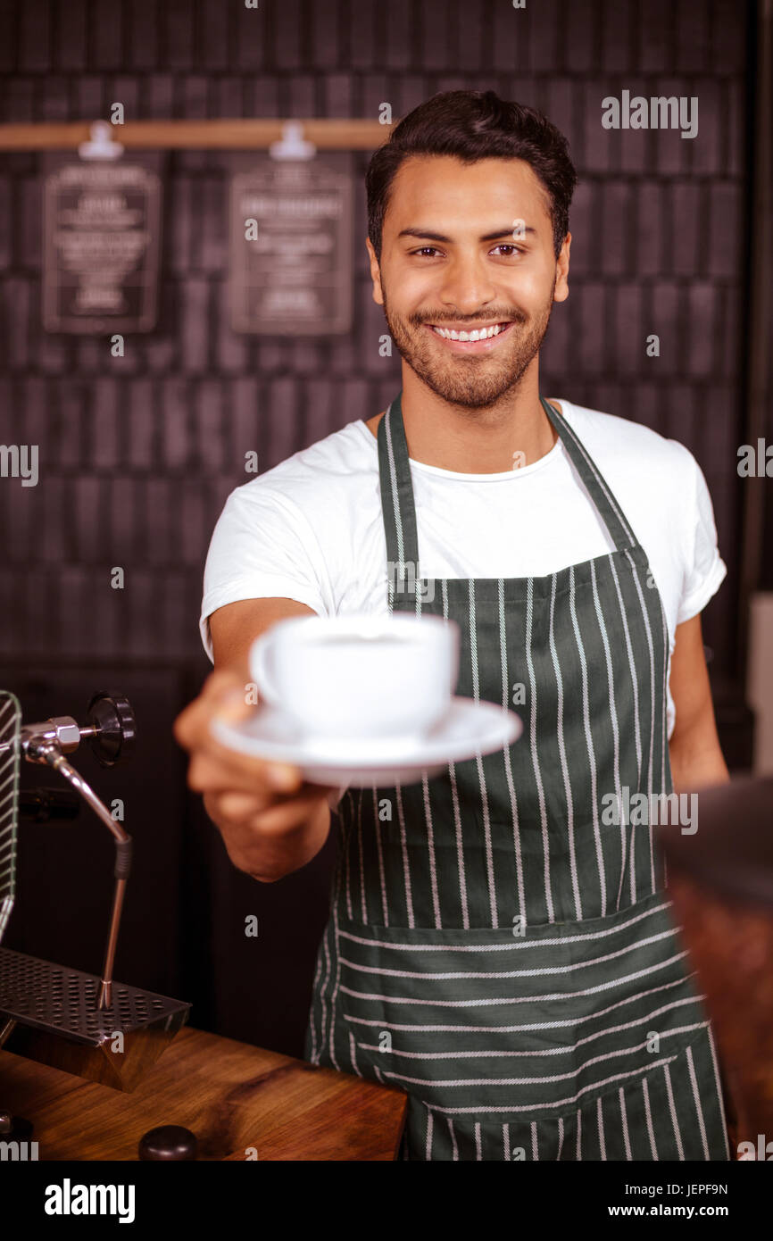 Smiling barista holding espresso Stock Photo - Alamy