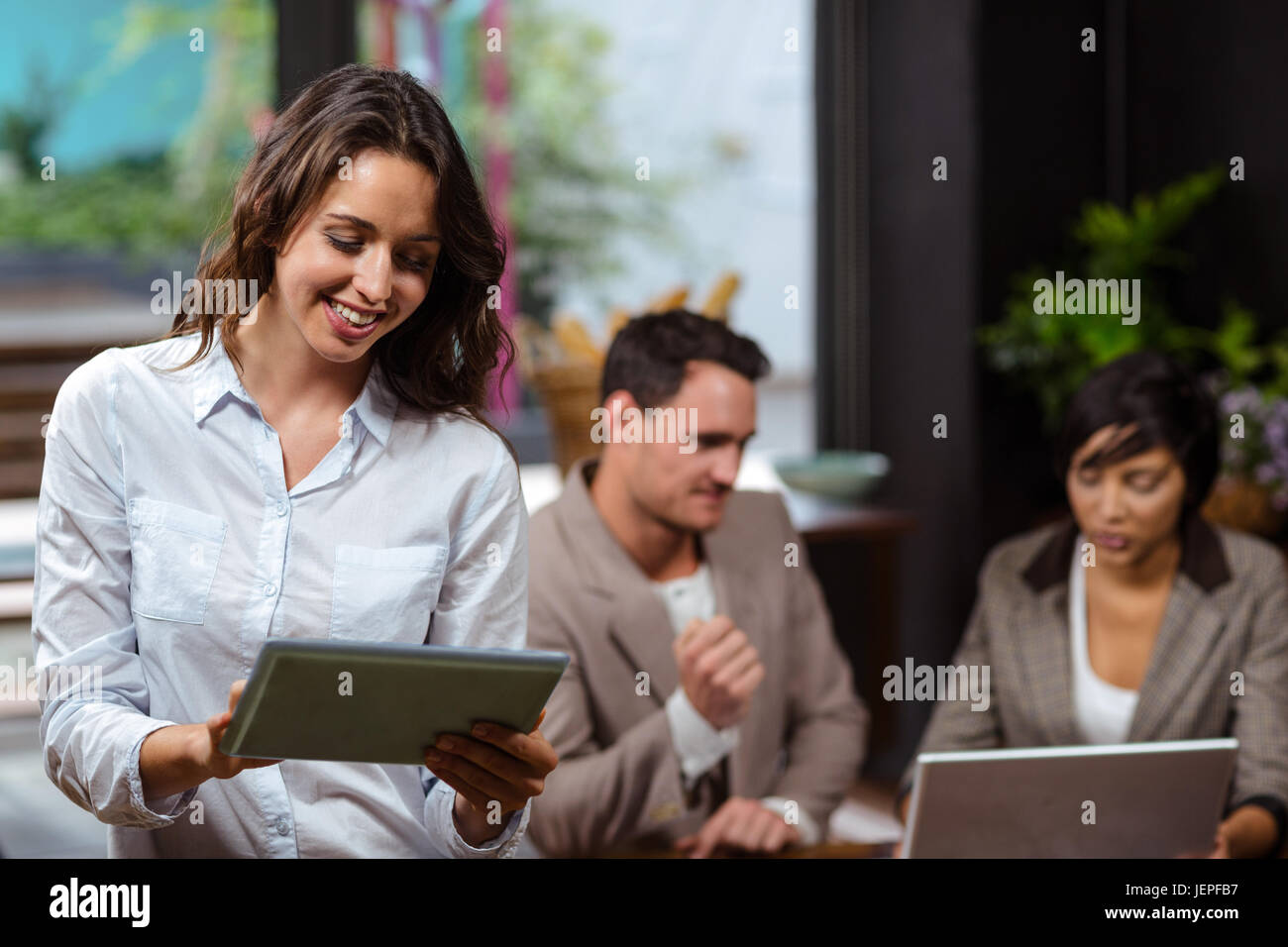 Friends using technology Stock Photo - Alamy