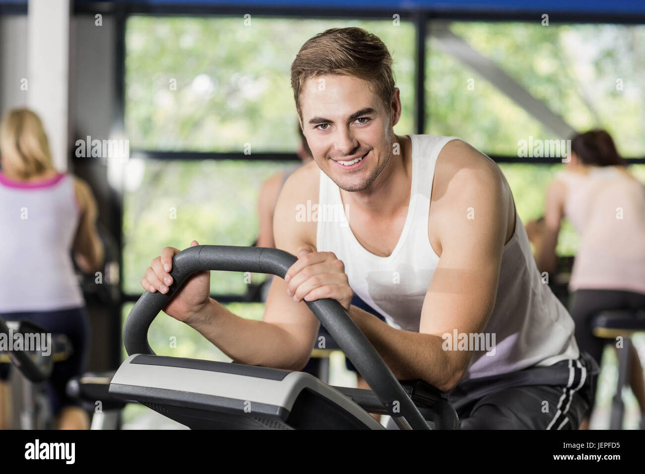 Fit man doing exercise bike Stock Photo - Alamy