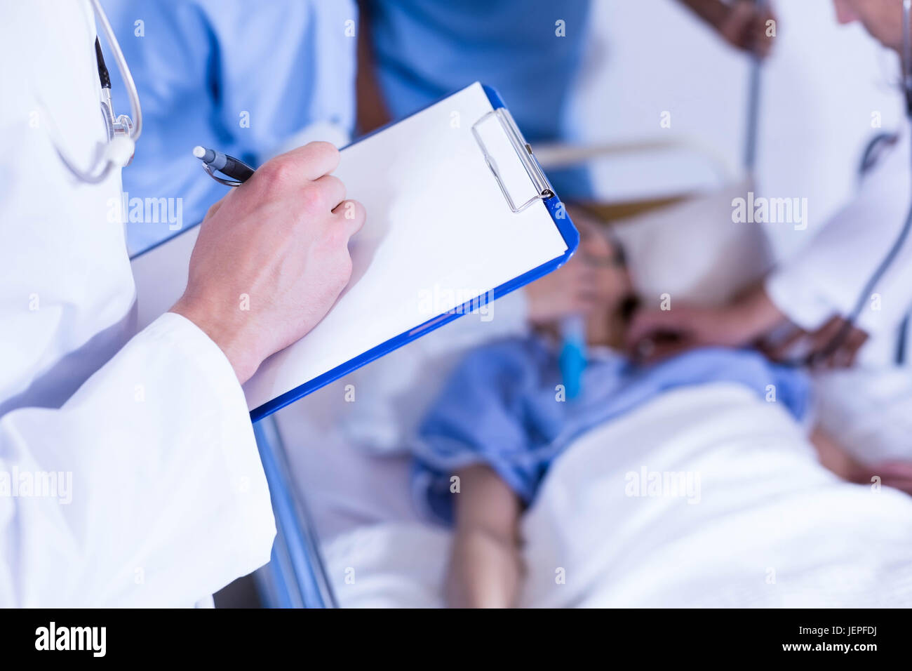 Doctor writing on clipboard Stock Photo - Alamy