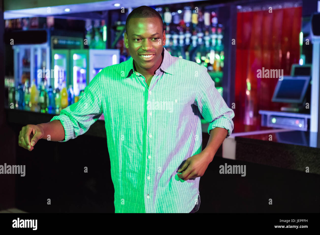 Happy man dancing in front of bar counter Stock Photo - Alamy