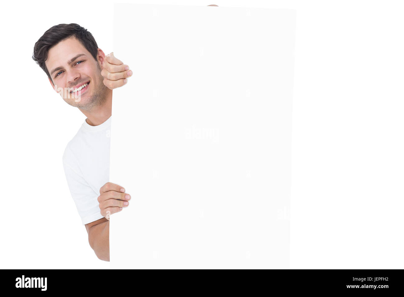 Handsome man looking over a white poster Stock Photo - Alamy