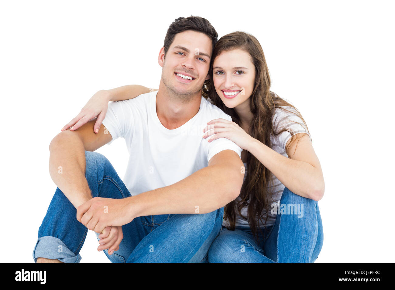 Young couple sitting on floor hugging Stock Photo - Alamy
