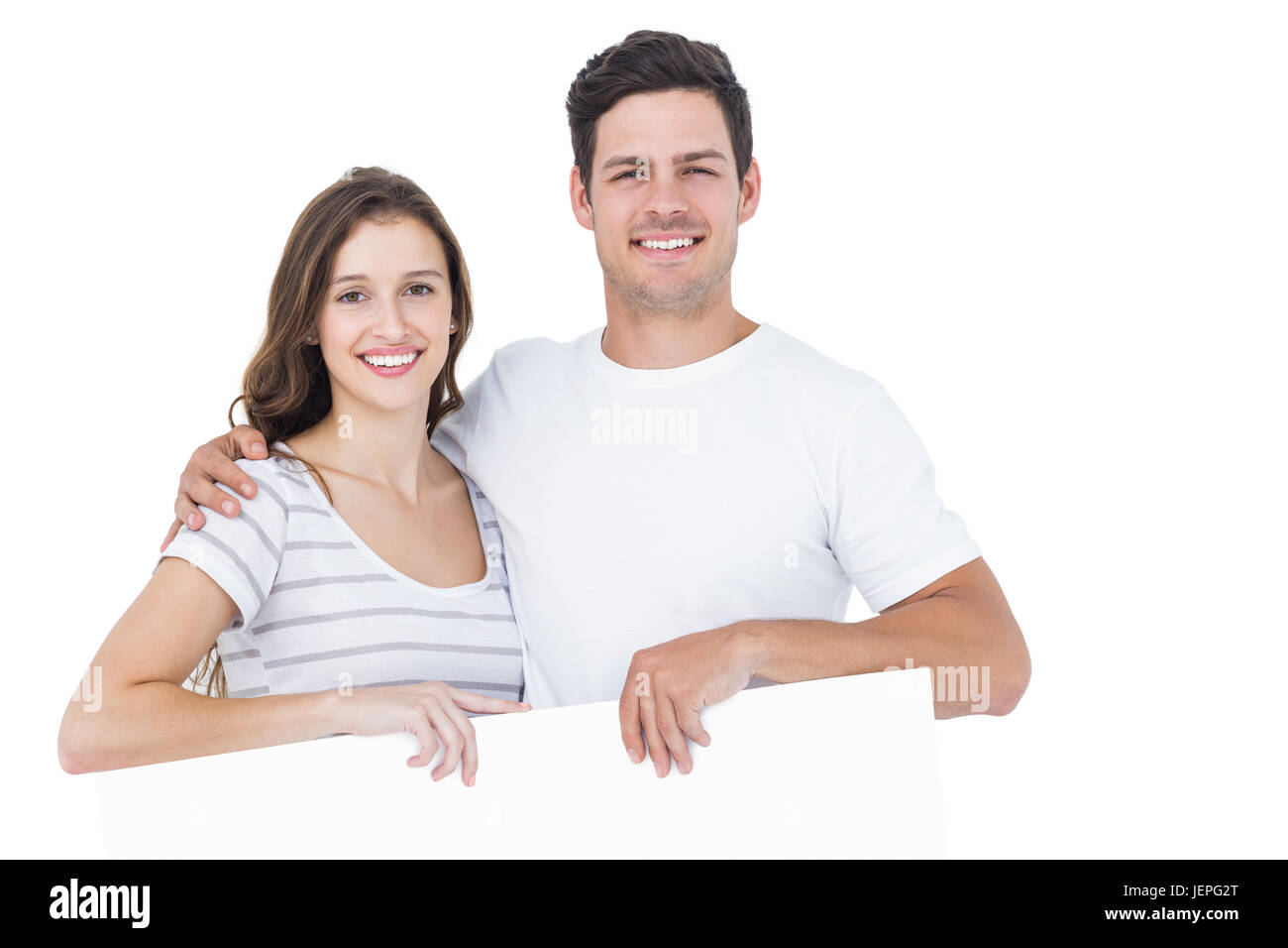 Happy couple holding a poster Stock Photo - Alamy