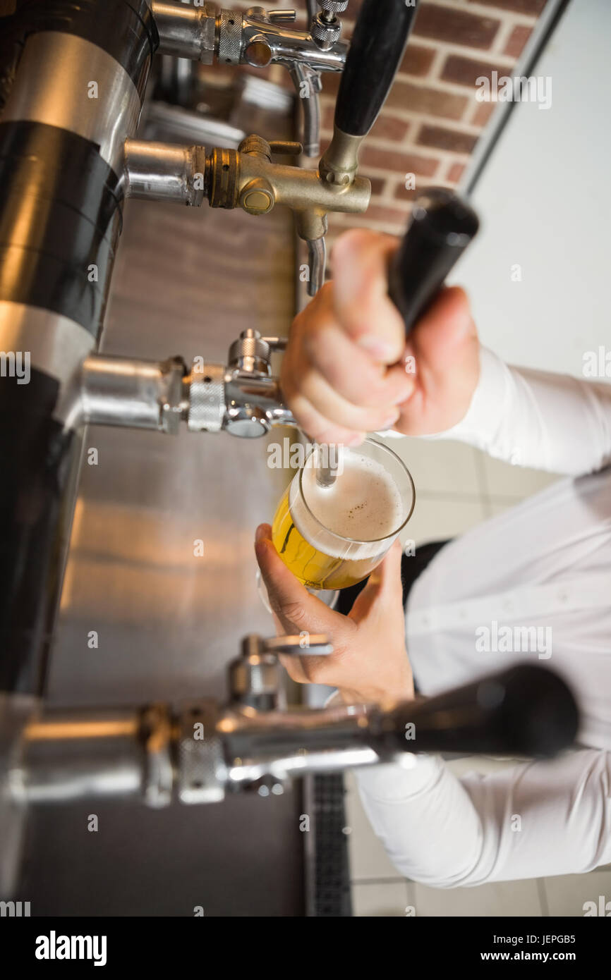 Handsome barman pouring a pint of beer Stock Photo - Alamy