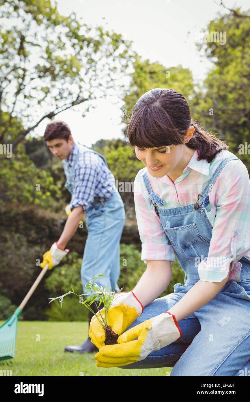 Young woman planting a sapling Stock Photo - Alamy