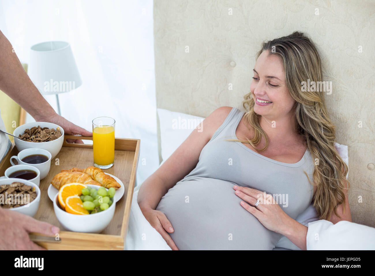 Pregnant woman on bed Stock Photo - Alamy