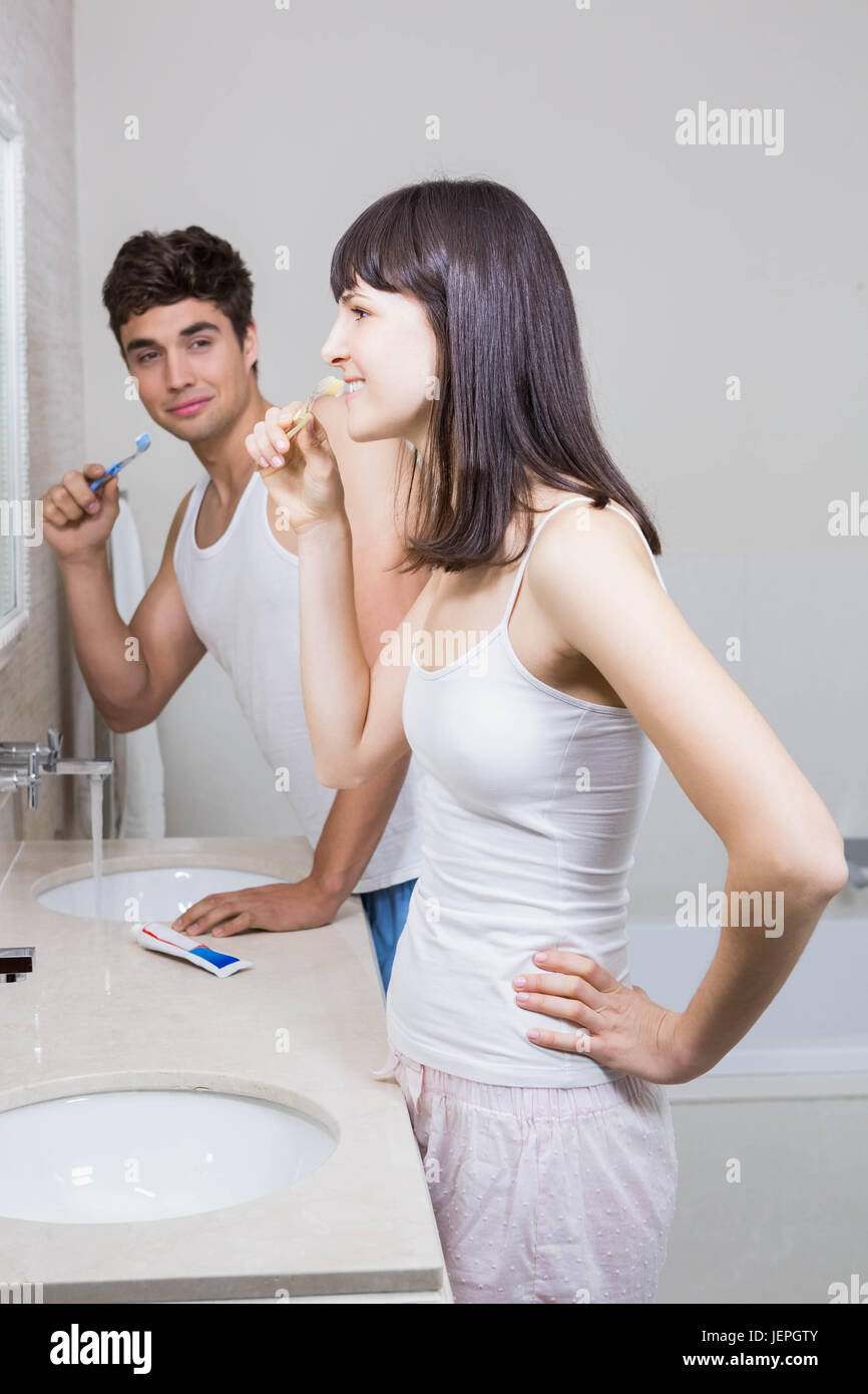 Bathroom routine for happy young couple Stock Photo - Alamy