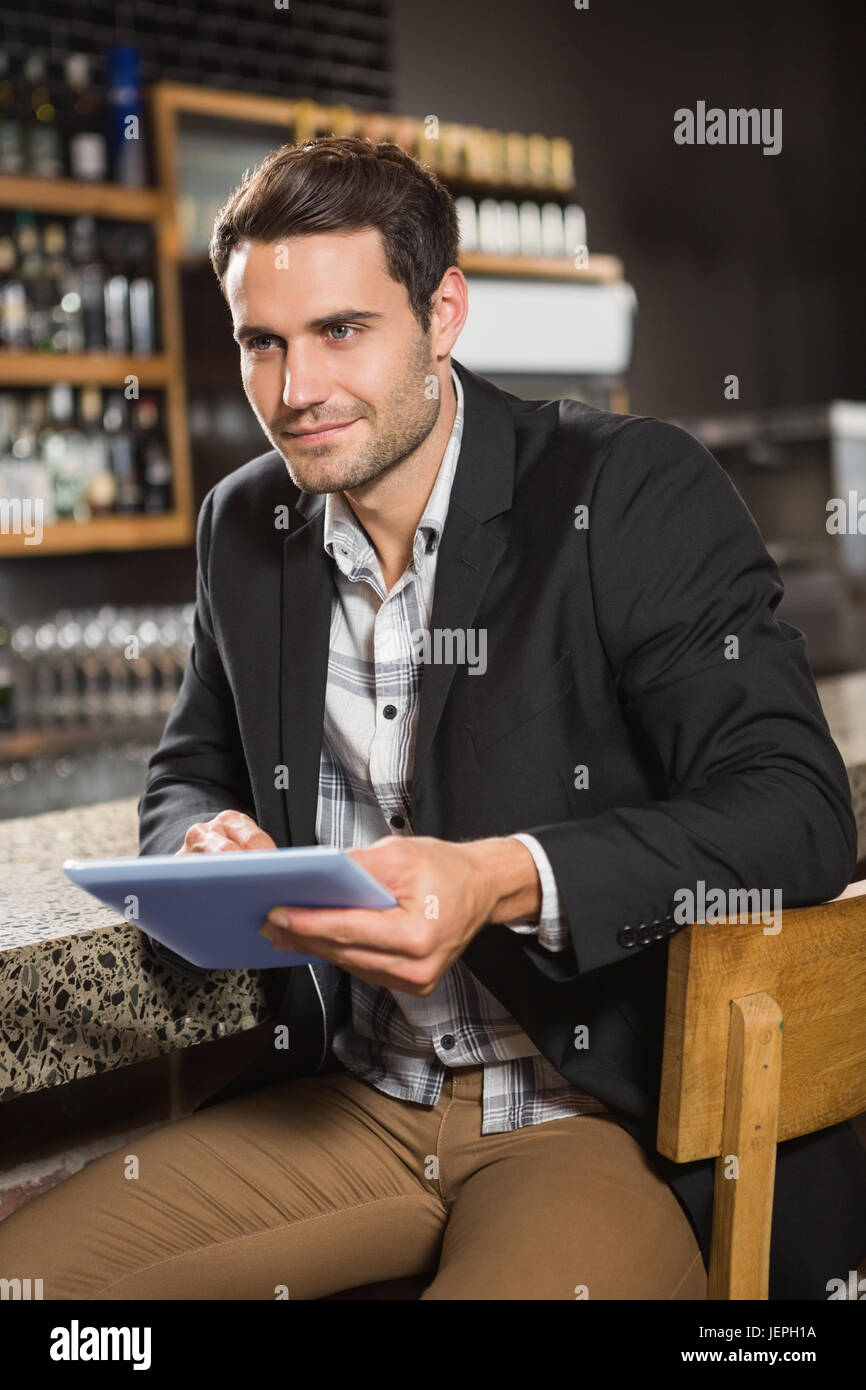Handsome man using tablet Stock Photo - Alamy
