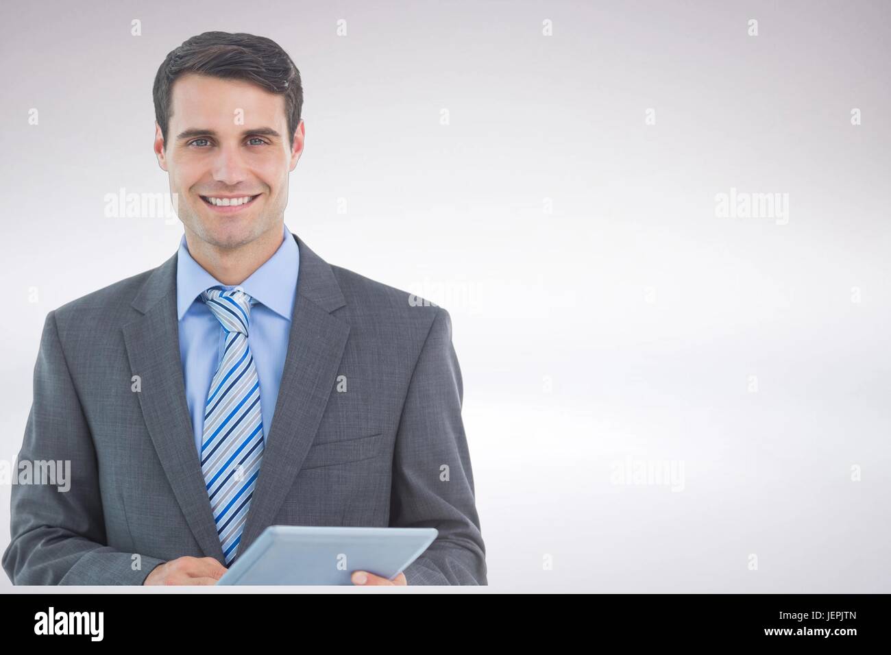 Smiling businessman holding tablet Stock Photo - Alamy