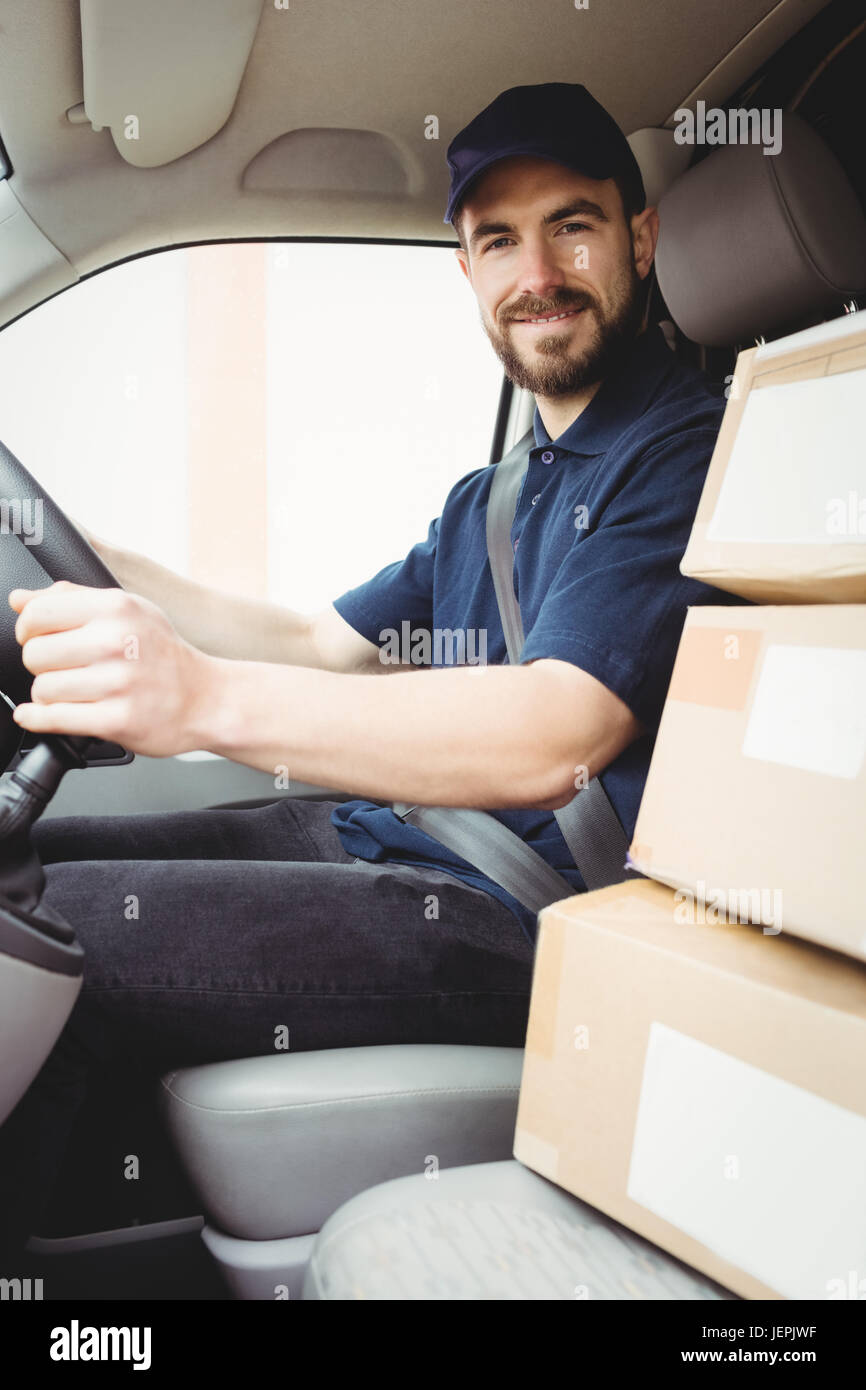 Delivery man driving his van Stock Photo - Alamy