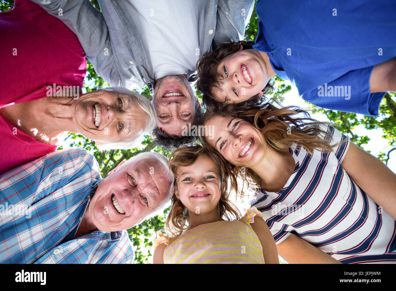 Smiling family with their heads in a circle Stock Photo - Alamy