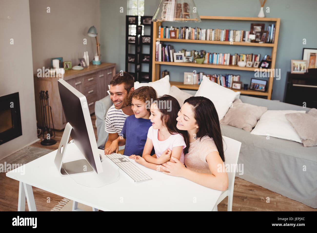 Happy family using computer at home Stock Photo - Alamy