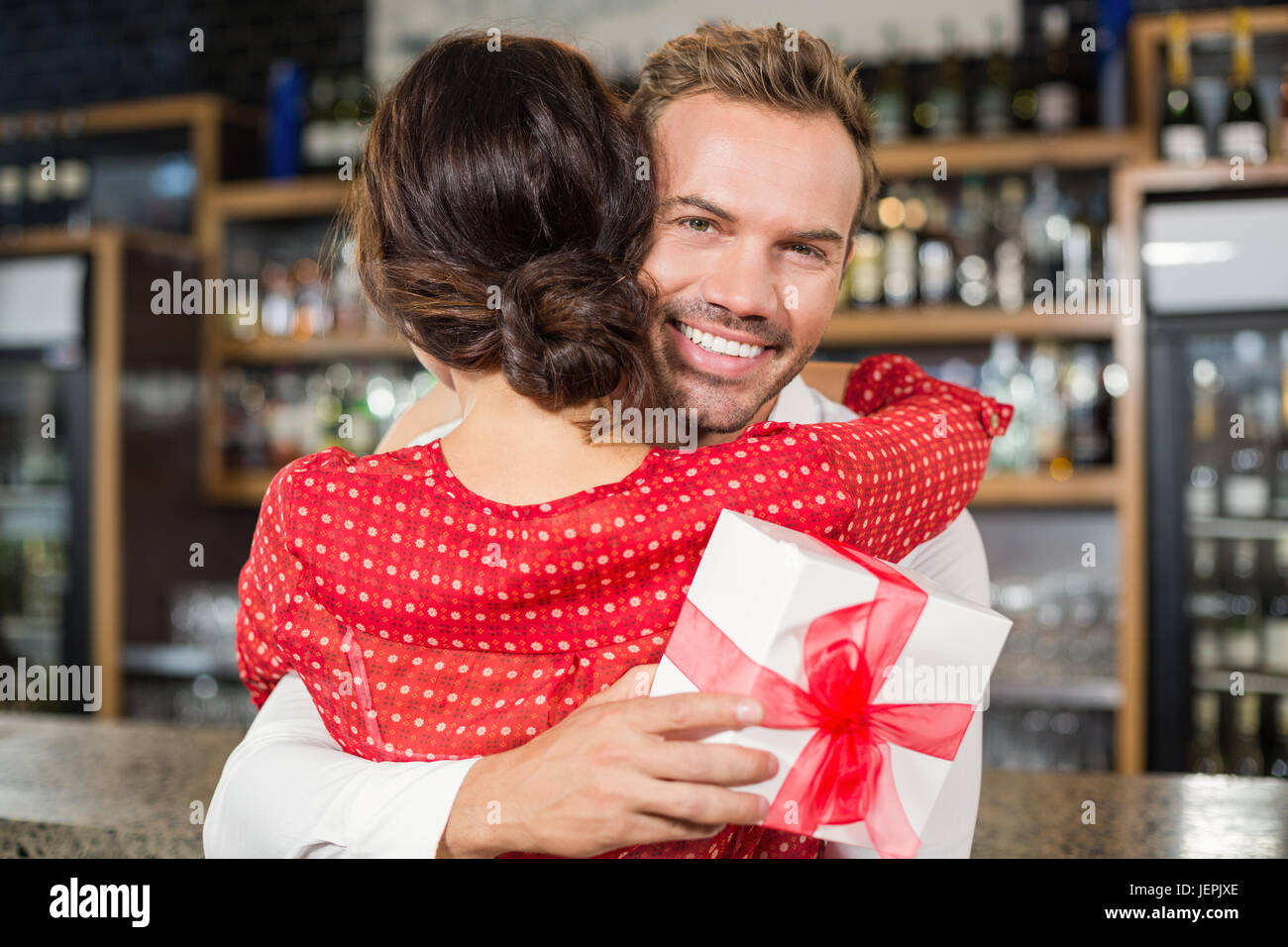A couple hugging in a bar Stock Photo - Alamy