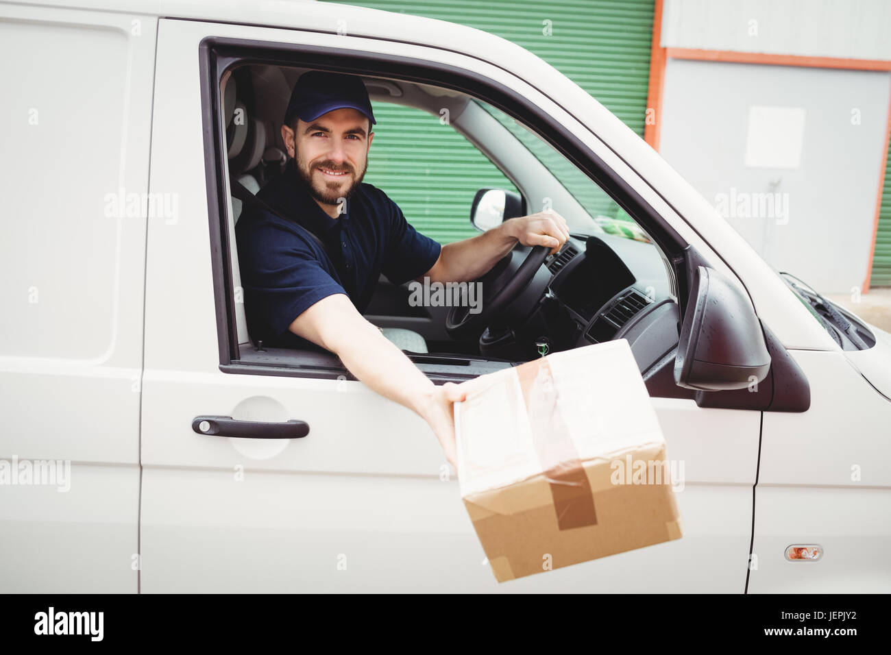 Delivery man sitting in his van Stock Photo - Alamy