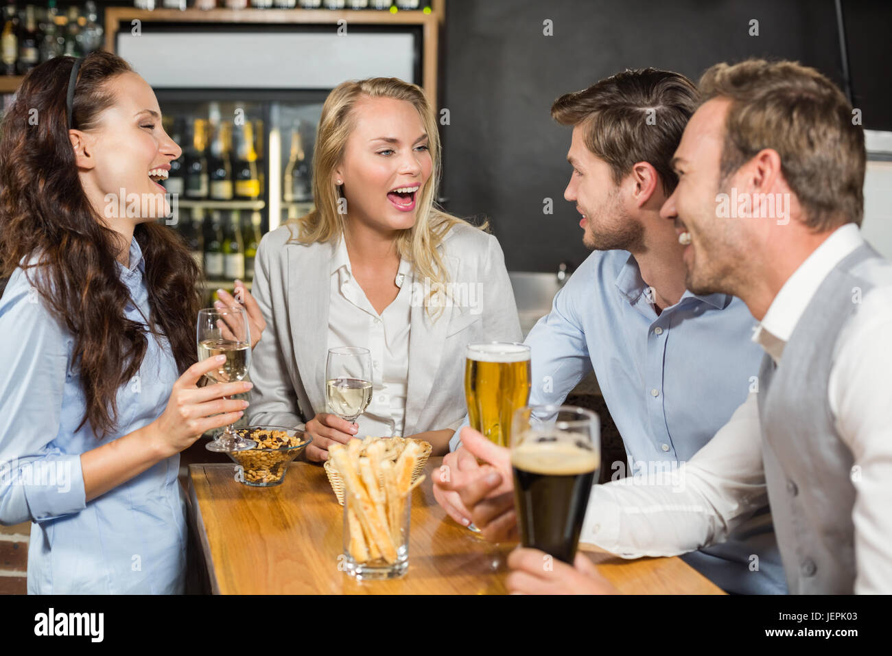 Man woman talking at bar standing holding drink hi-res stock ...