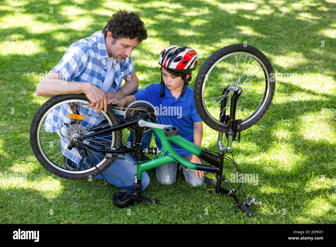 Father and son fixing the bike Stock Photo - Alamy