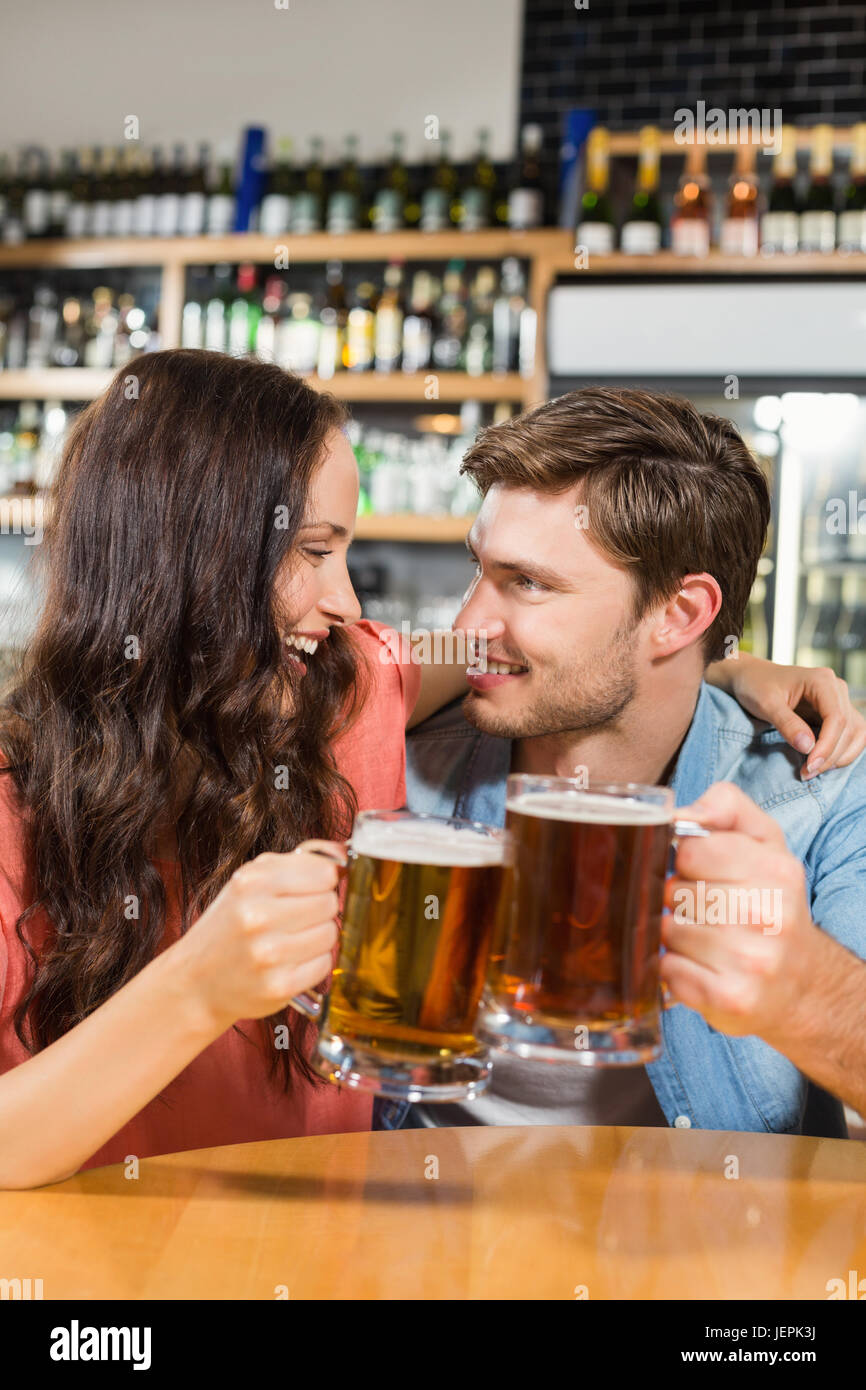 Couple toasting with beers Stock Photo - Alamy