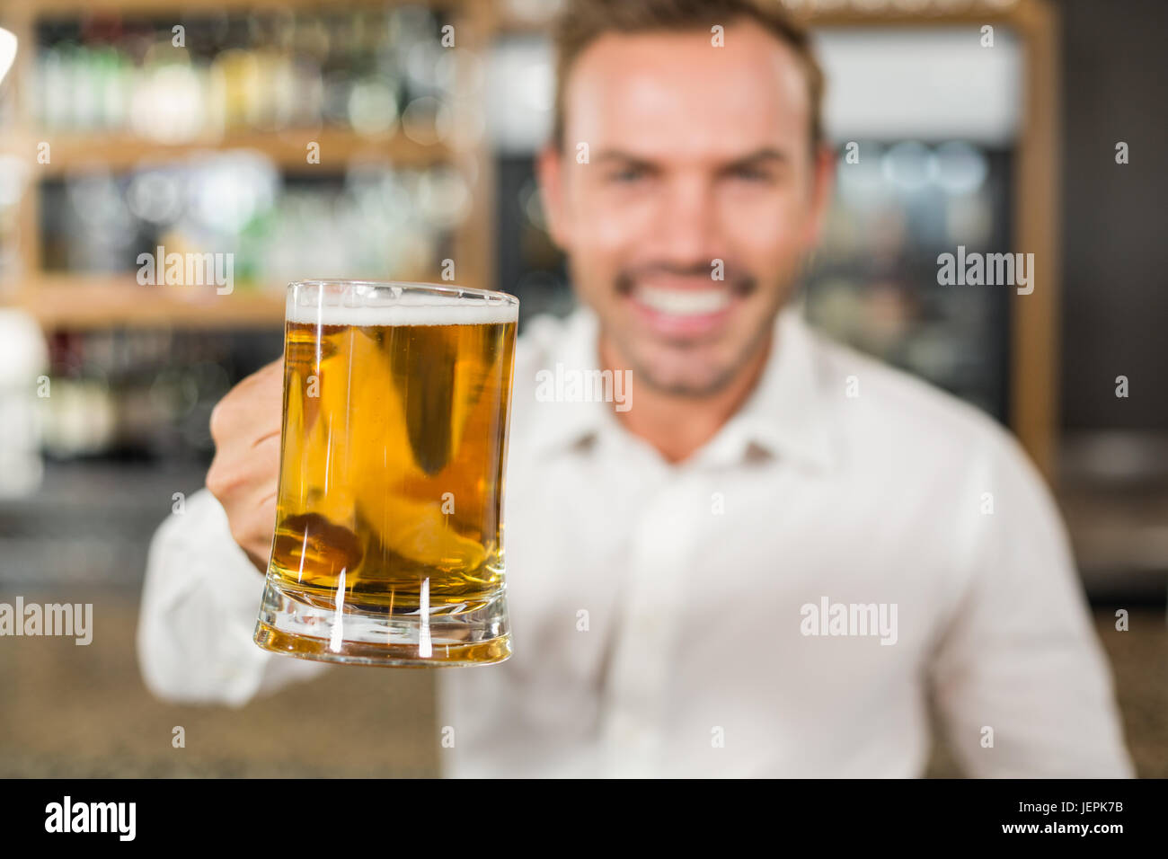 Handsome man toasting Stock Photo - Alamy