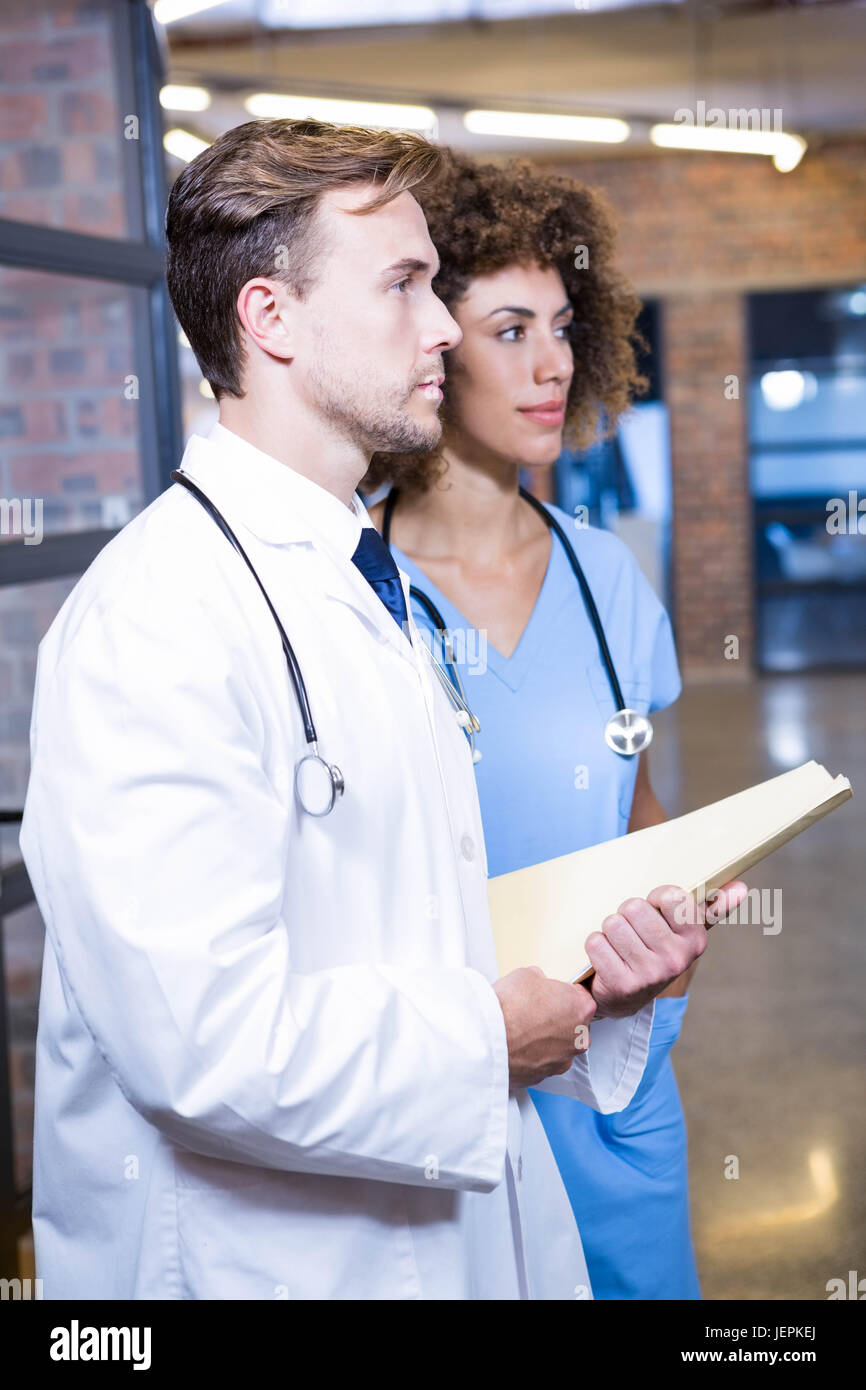Doctor and nurse with medical report Stock Photo - Alamy