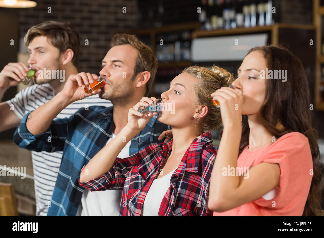 Friends drinking shots Stock Photo - Alamy
