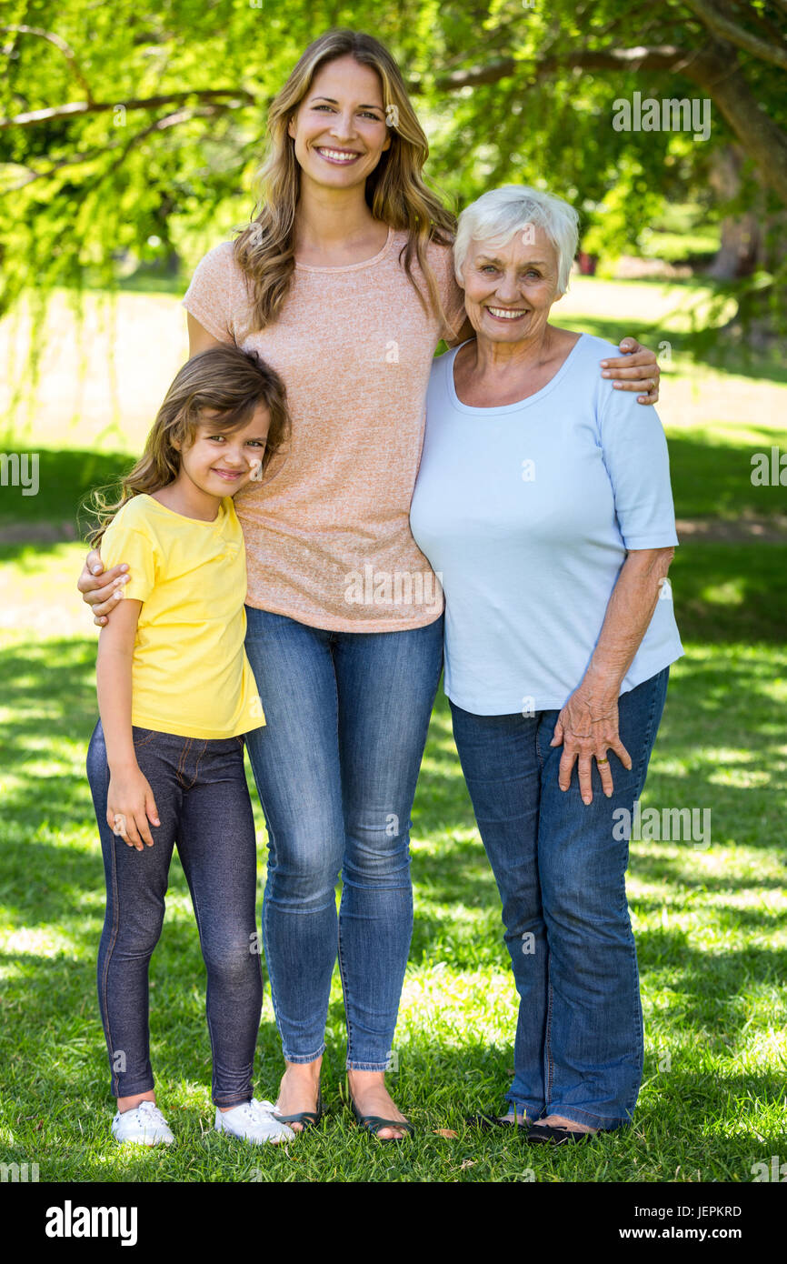 Smiling family standing Stock Photo - Alamy
