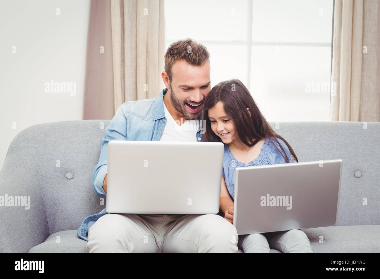 Father and daughter using laptop Stock Photo - Alamy