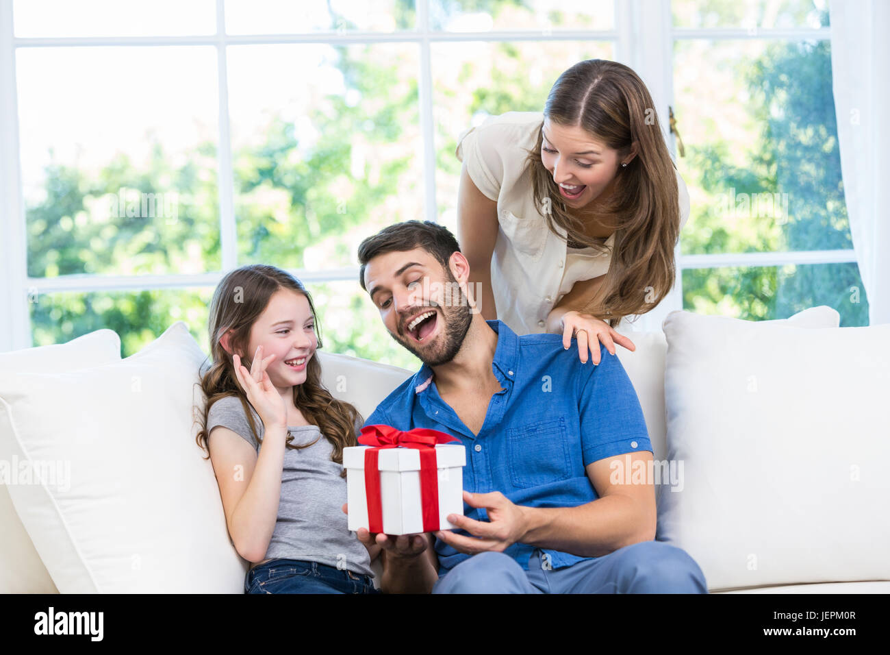 Man surprised with gift given by family Stock Photo - Alamy