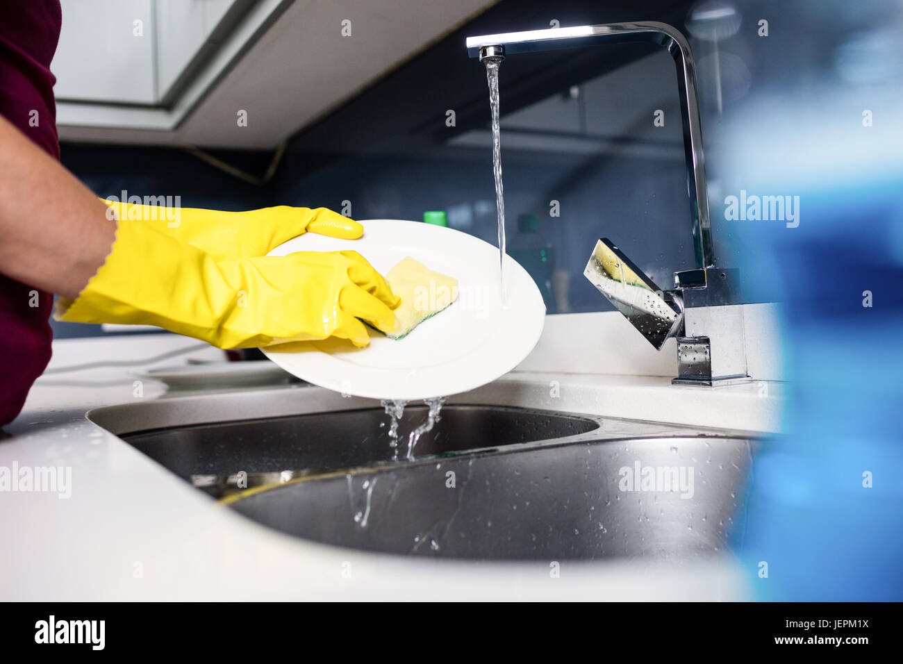 Cropped hand of woman washing plate Stock Photo - Alamy