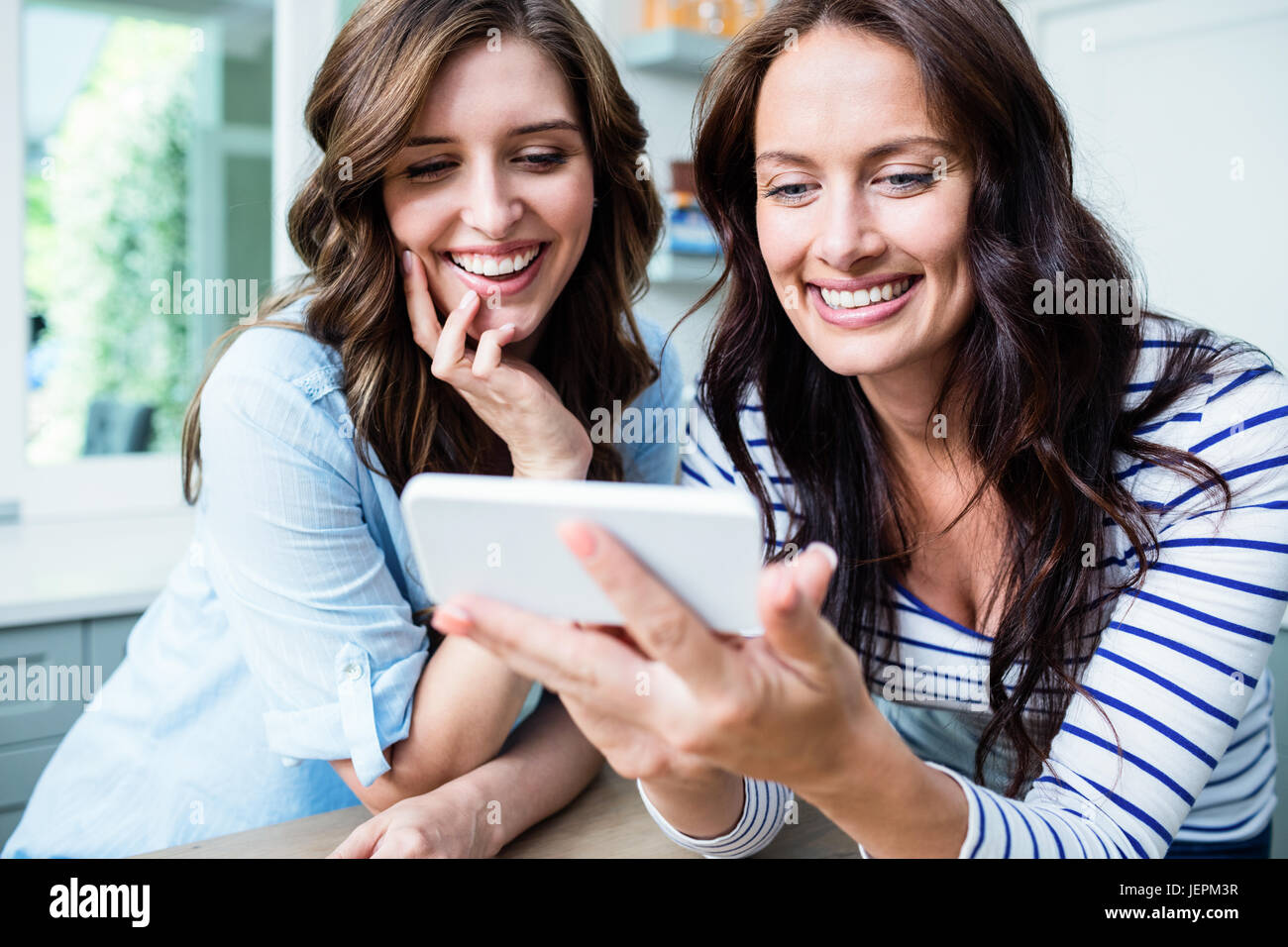 Cheerful female friends using hi-res stock photography and images - Alamy