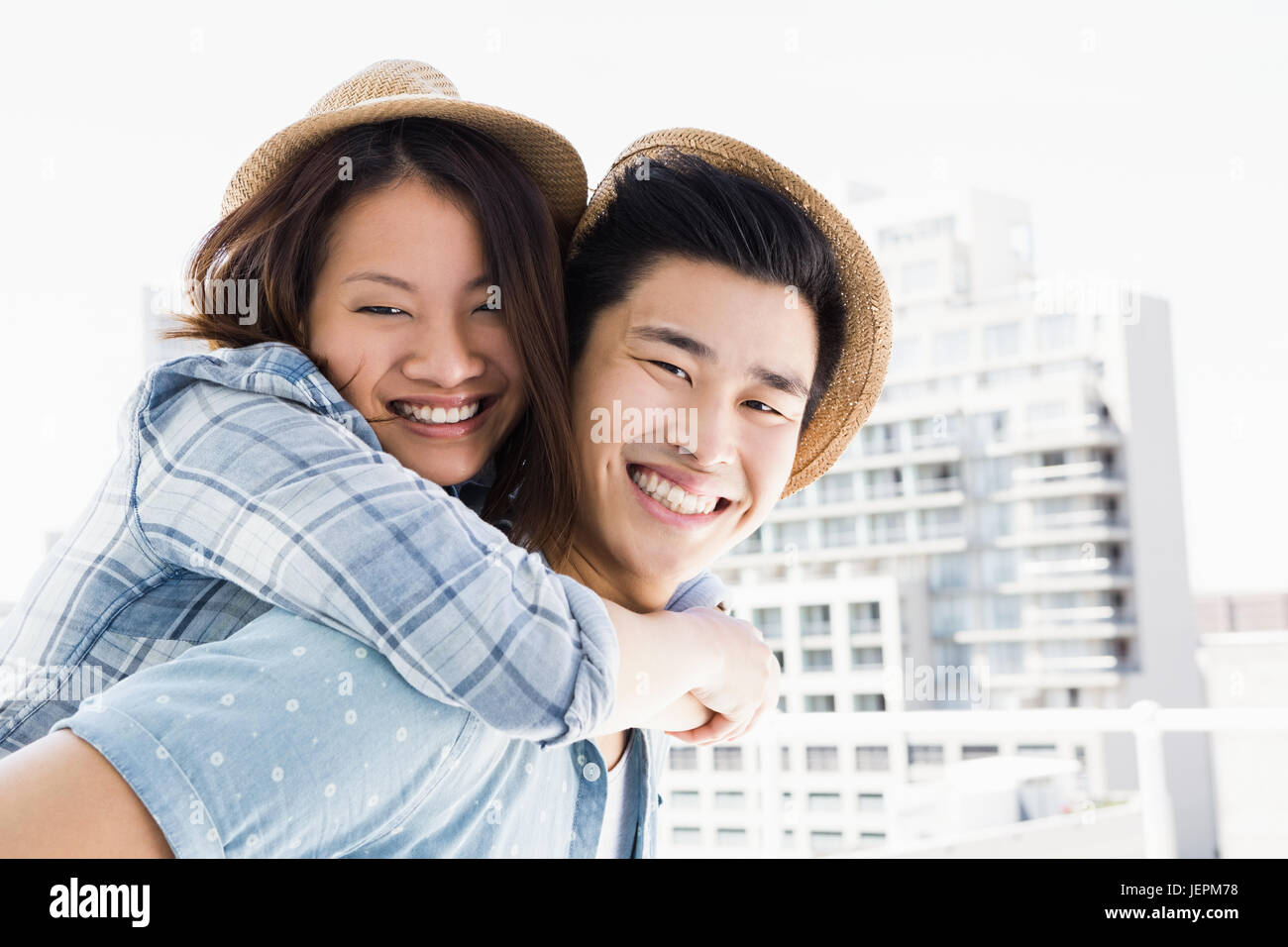 Young man giving a piggyback ride to woman Stock Photo - Alamy