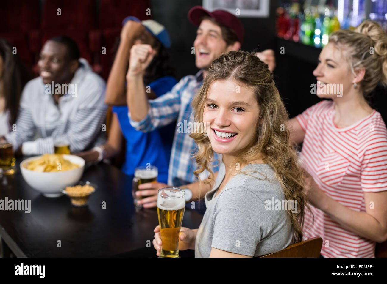 Happy friends watching sport Stock Photo - Alamy