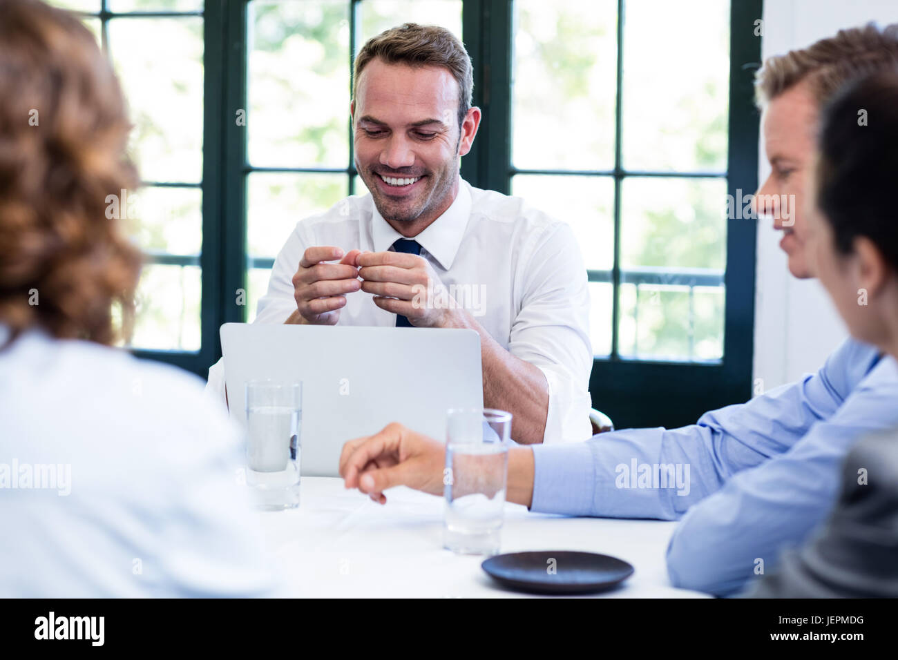 Businessman smiling in a business meeting Stock Photo - Alamy
