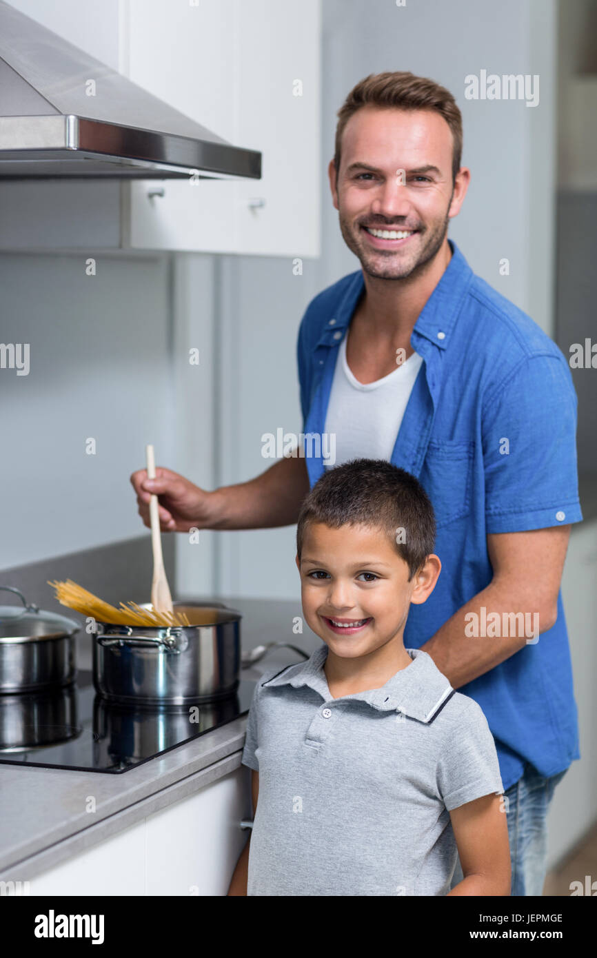 Young man cooking spaghetti Stock Photo - Alamy