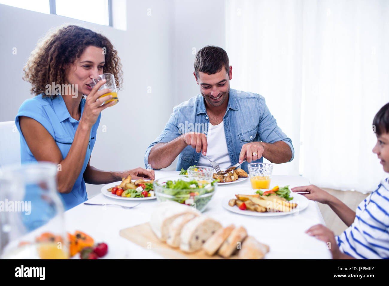 Family sitting at breakfast table Stock Photo - Alamy