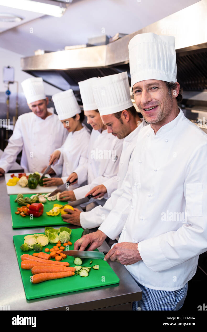 Team of chefs chopping vegetables Stock Photo - Alamy