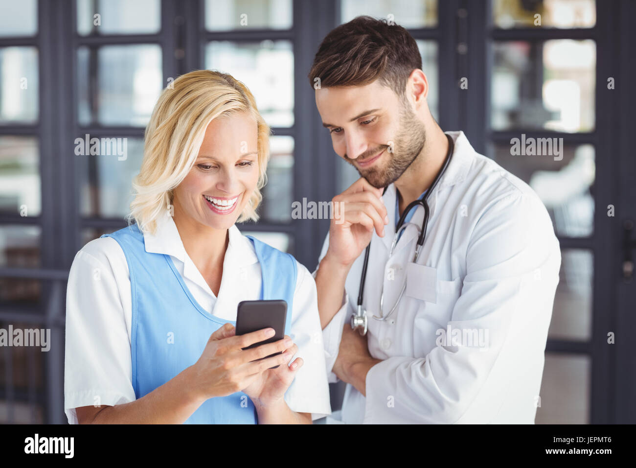 Female male doctor using mobile hi-res stock photography and images - Alamy